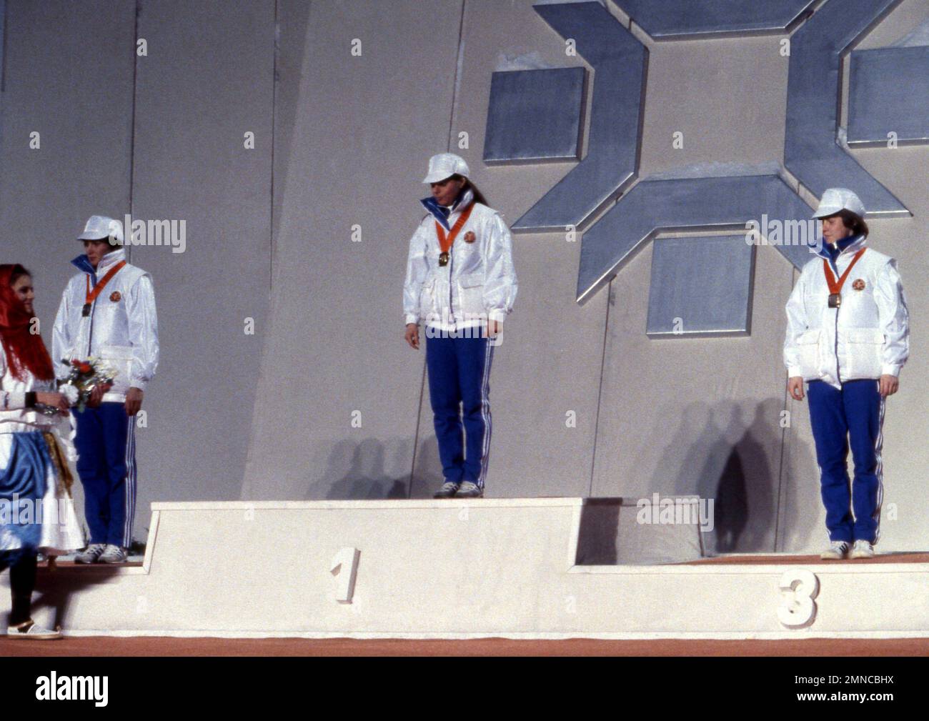 East Germany's Andrea Schoene, center, with Karen Enke of East Germany ...