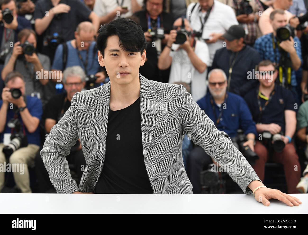 Actor Teo Yoo poses for photographers during a photo call for the film ...