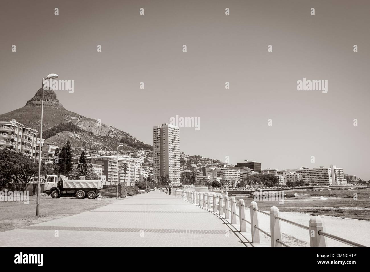 Mountains, hotels and deep blue water with waves at the Sea Point ...
