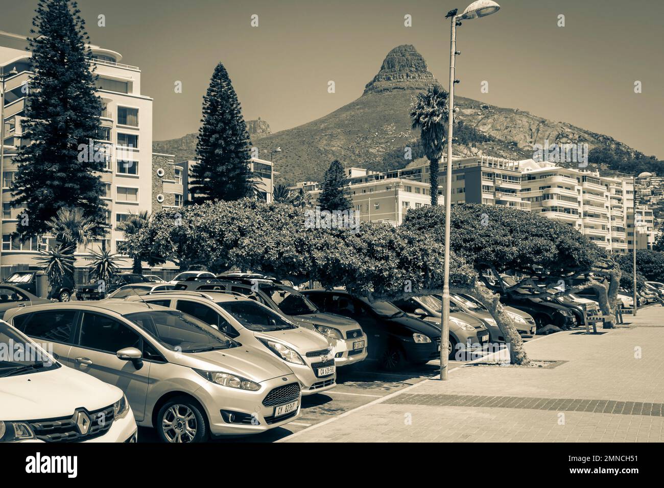 Mountains, hotels and parking cars at the Sea Point, beach promenade in ...