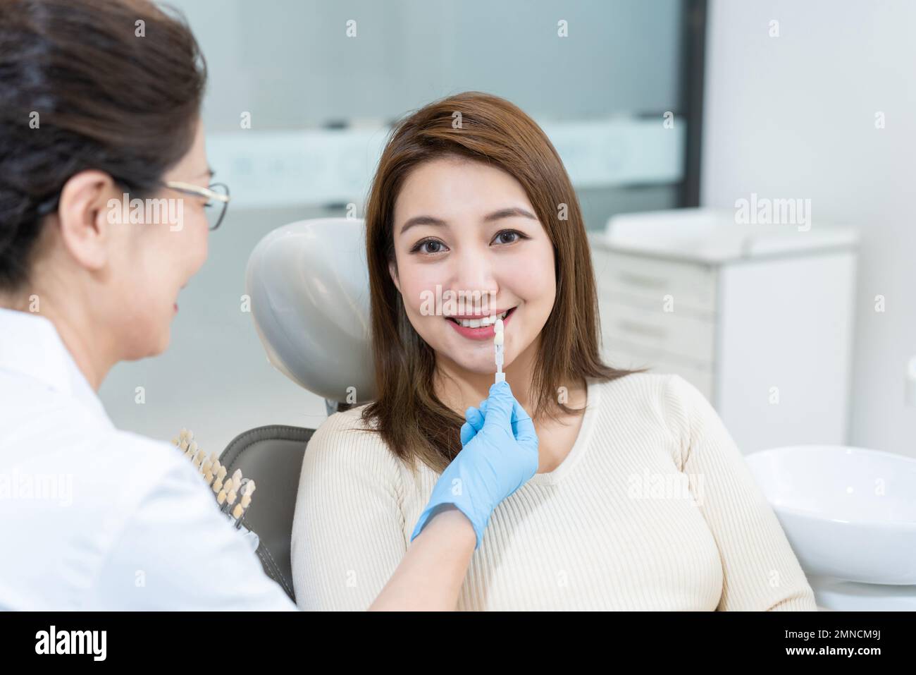 Doctors give patients in the dental clinic matching teeth Stock Photo ...