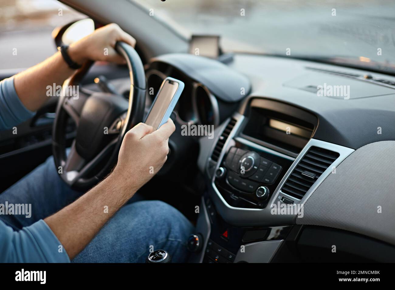 Hands of unrecognizable man driver using mobile phone while driving ... Hands of unrecognizable man driver using mobile phone while driving ...