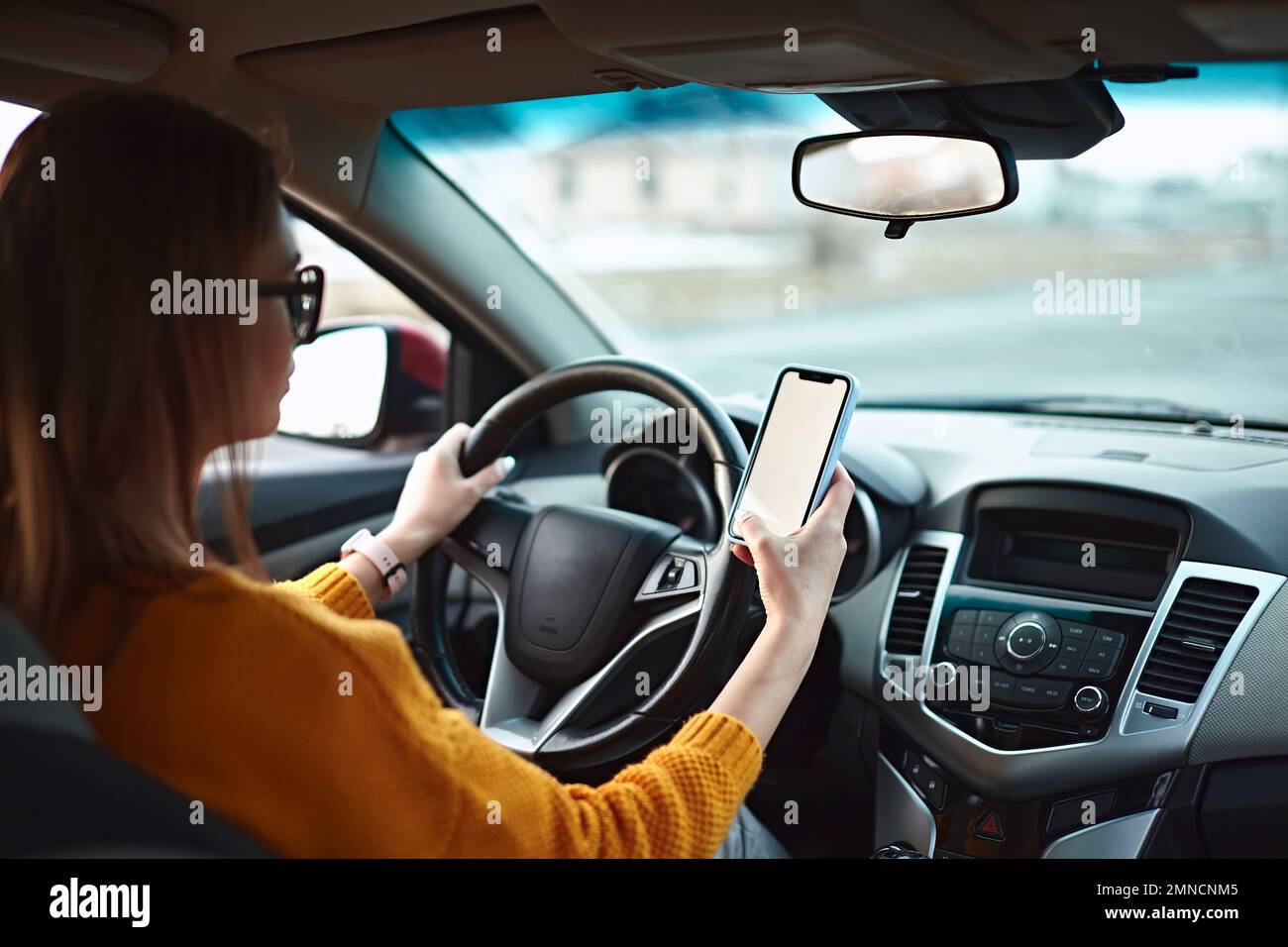 woman driver using mobile phone screen blank mockup on the road while ...