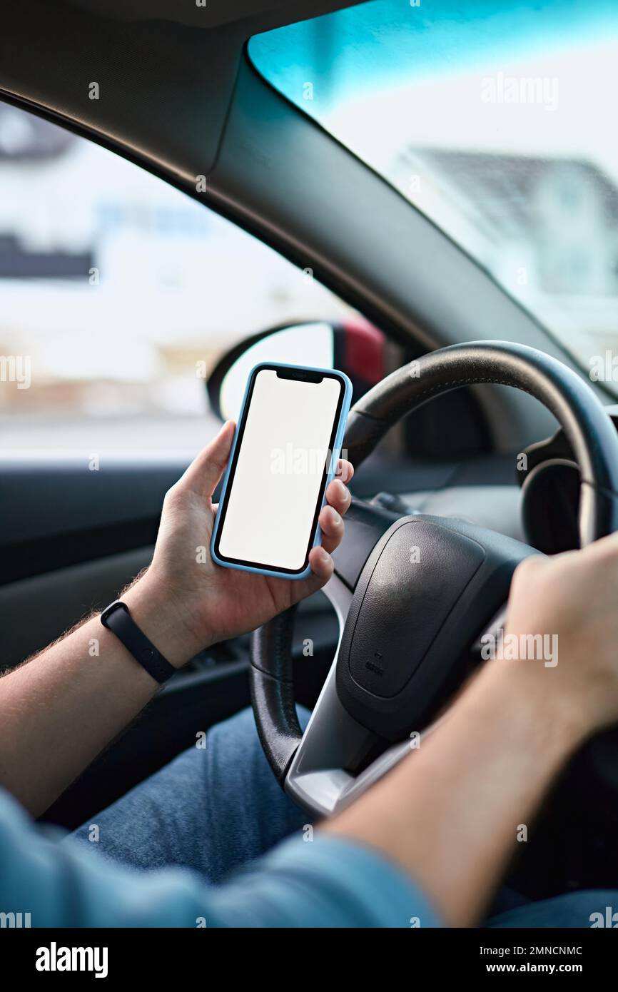Close up Hands of unrecognizable man driver using white screen mockup ...