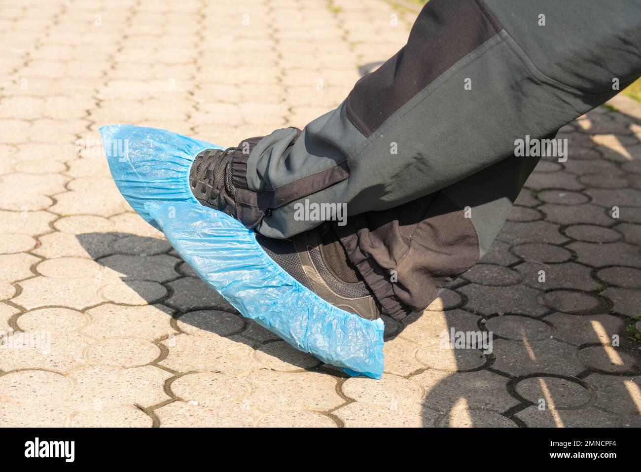 Close-up of person feet wearing shoe-covers for protection outside in ...