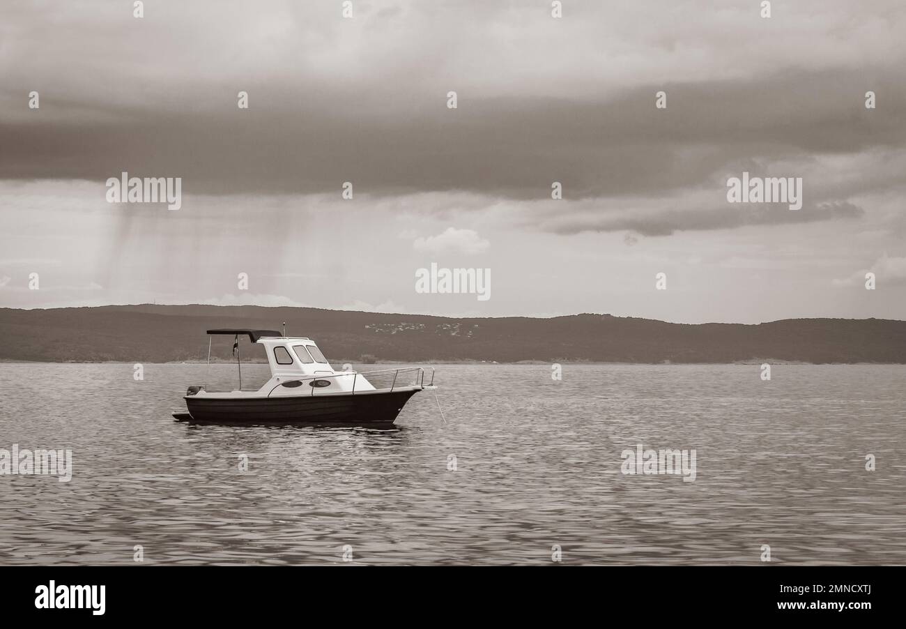 Huge rain clouds and showers in the background of a boat in Novi ...