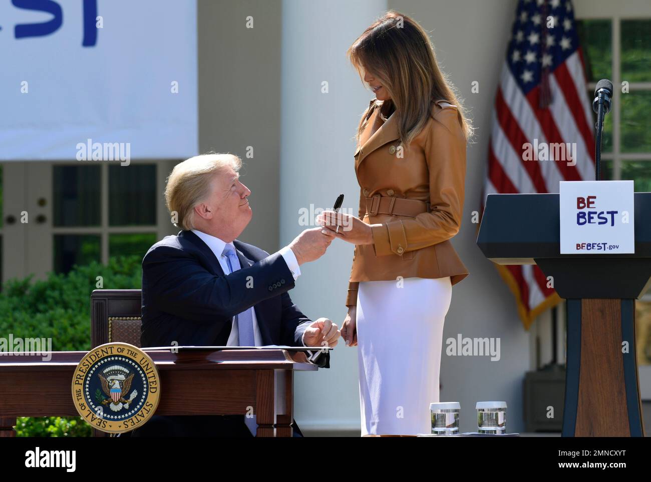 President Donald Trump gives first lady Melania Trump a pen he used to ...