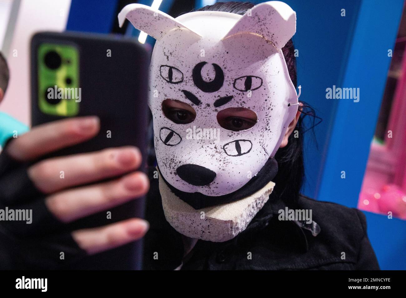 Moscow, Russia. 28th of January, 2023. Young man in fanny mask reading ...