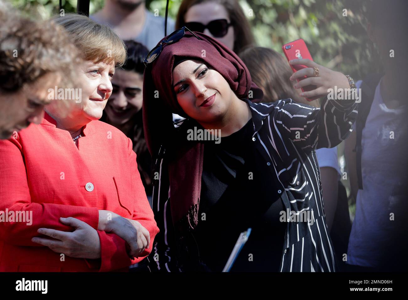 German Chancellor Angela Merkel, left, poses for a photo with a student ...