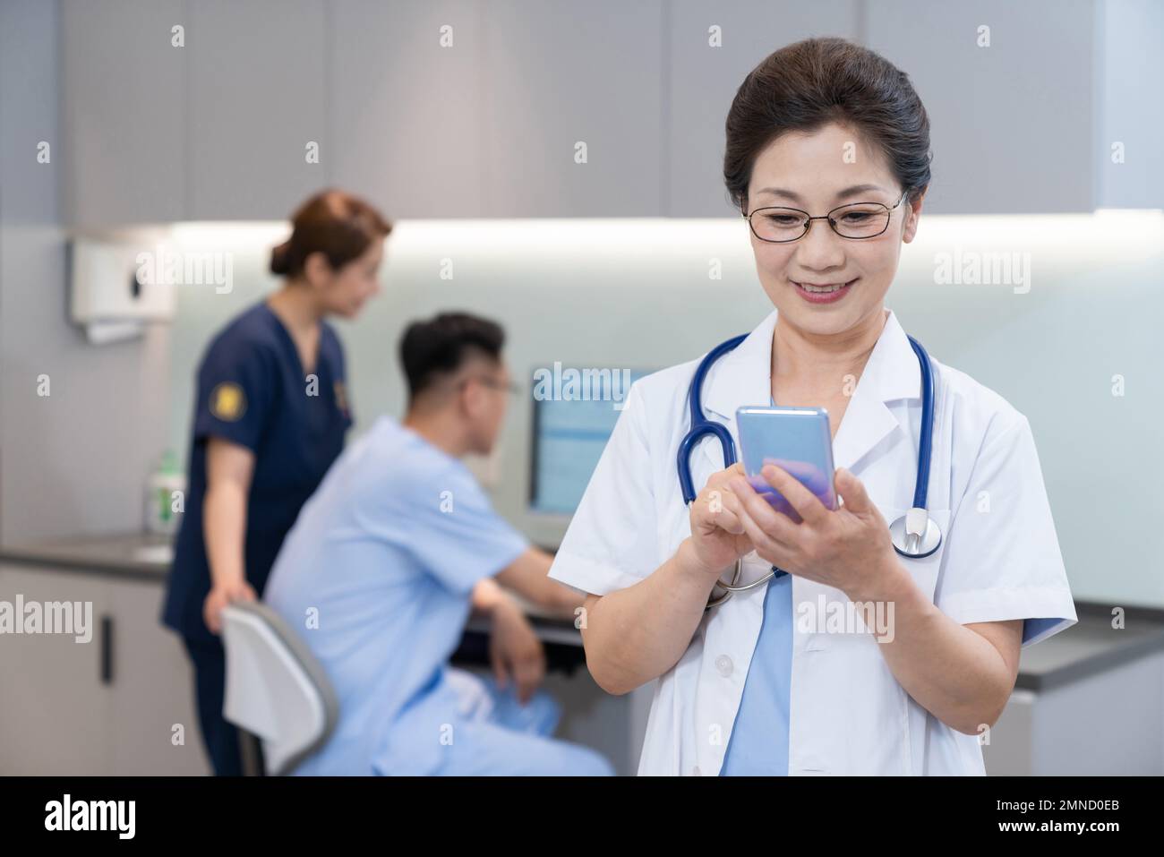 Doctors use mobile phones in dental clinic Stock Photo - Alamy