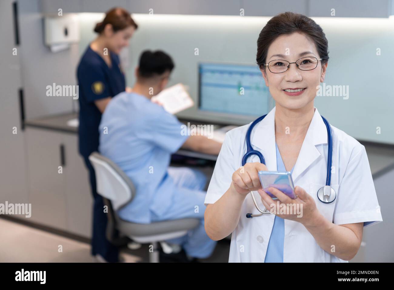 Doctors use mobile phones in dental clinic Stock Photo - Alamy