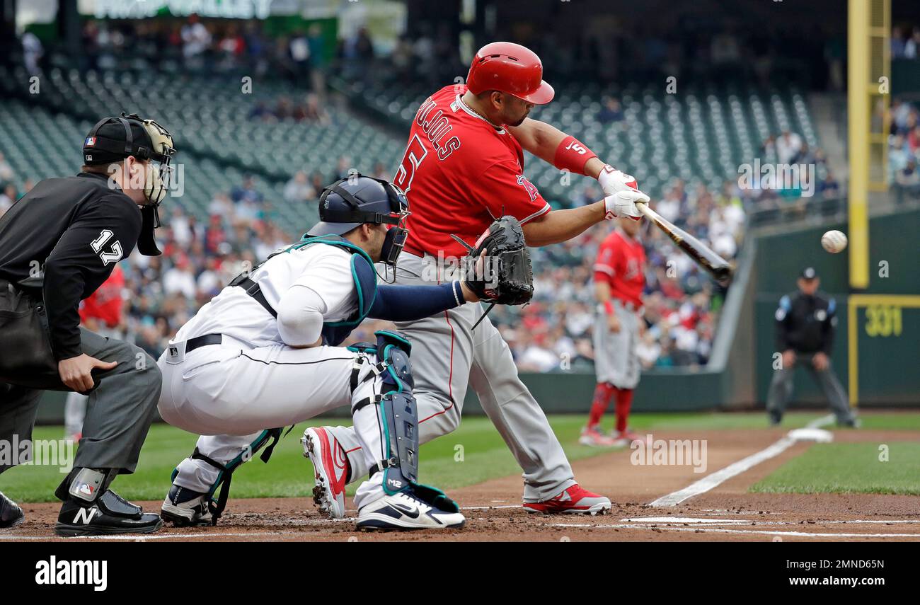 Los Angeles Angels' Albert Pujols hits an RBI sacrifice fly in front of ...