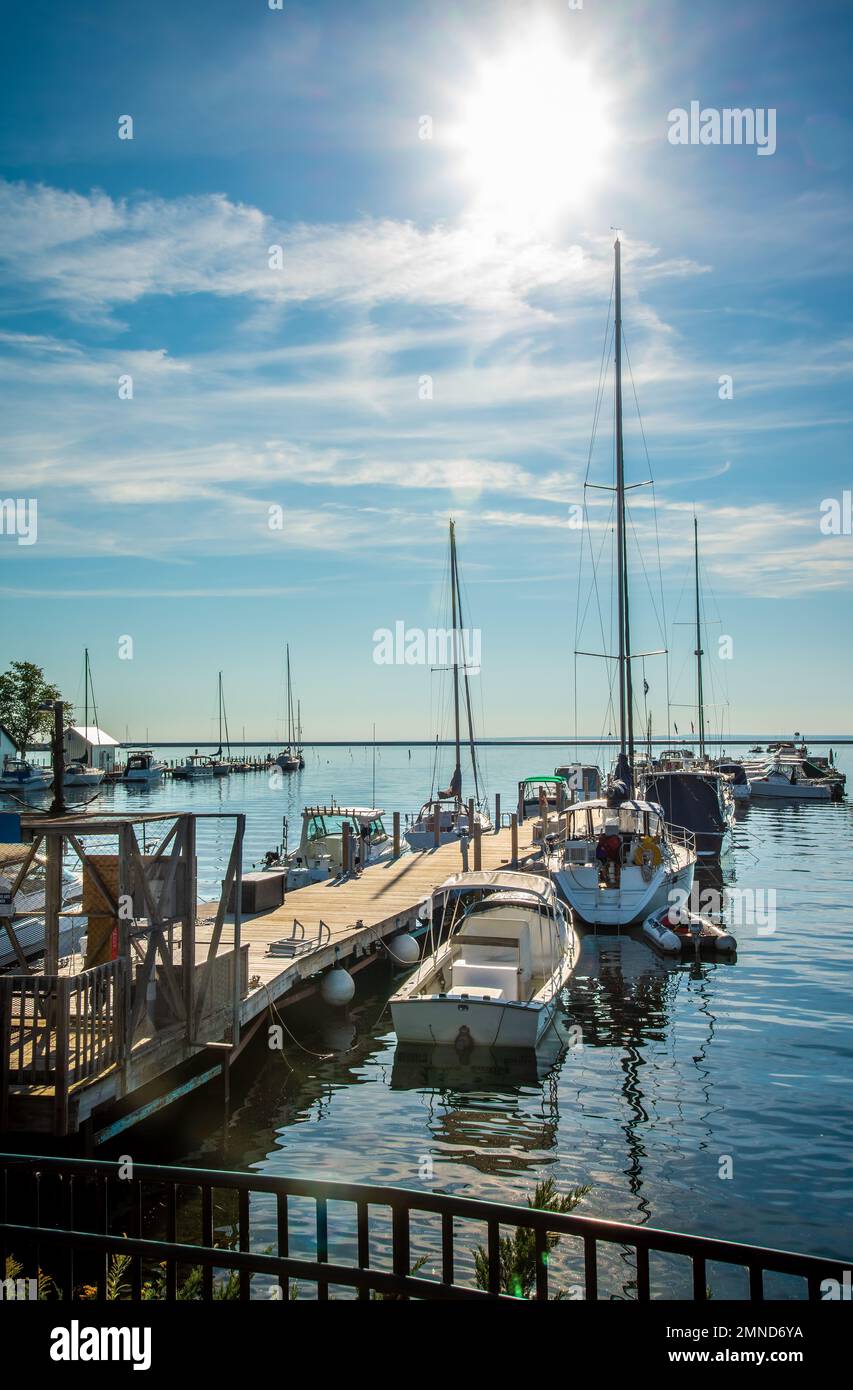 Boat Marina pier with sail boats tied under morning summer un shine ...