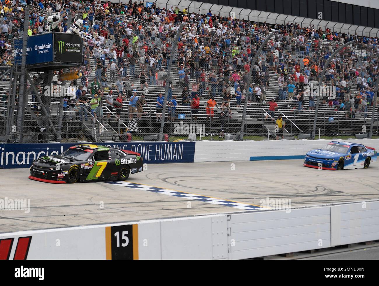 Justin Allgaier (7) takes the checkered flag in front of Elliott Sadler ...