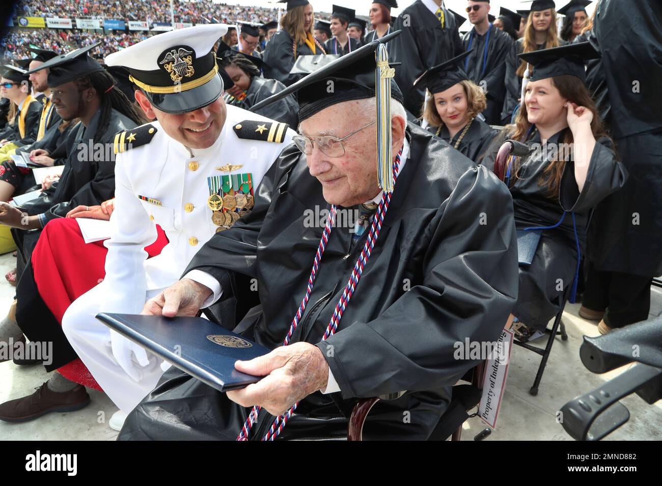 World War II veteran Bob Barger, assisted by Haraz Ghanbari, University ...