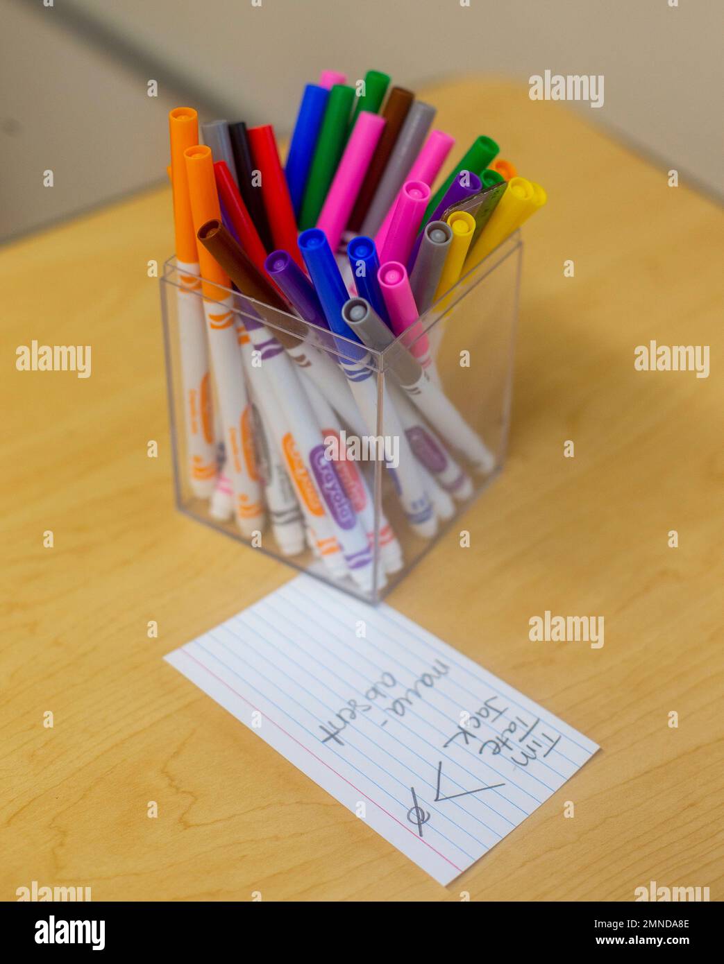 Markers on a desk in a classroom Stock Photo - Alamy