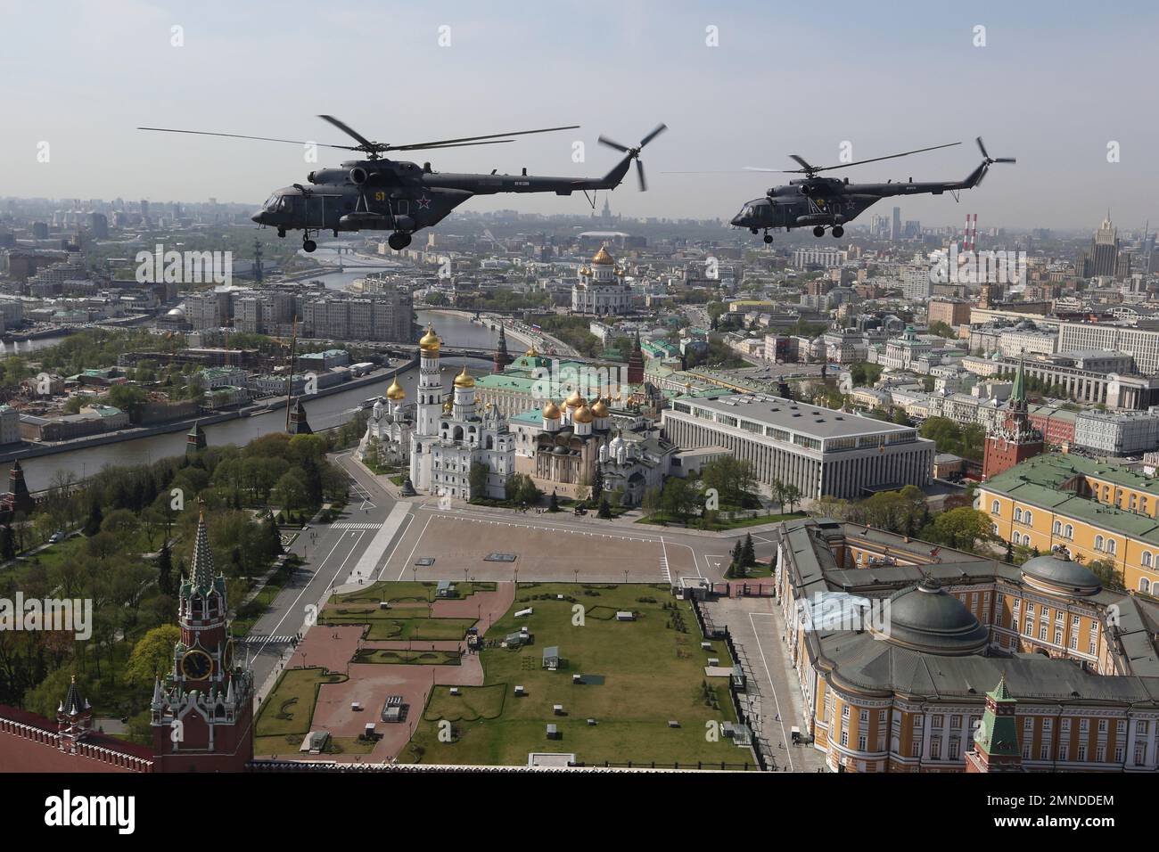 Russian military helicopters fly over the Kremlin complex during a ...