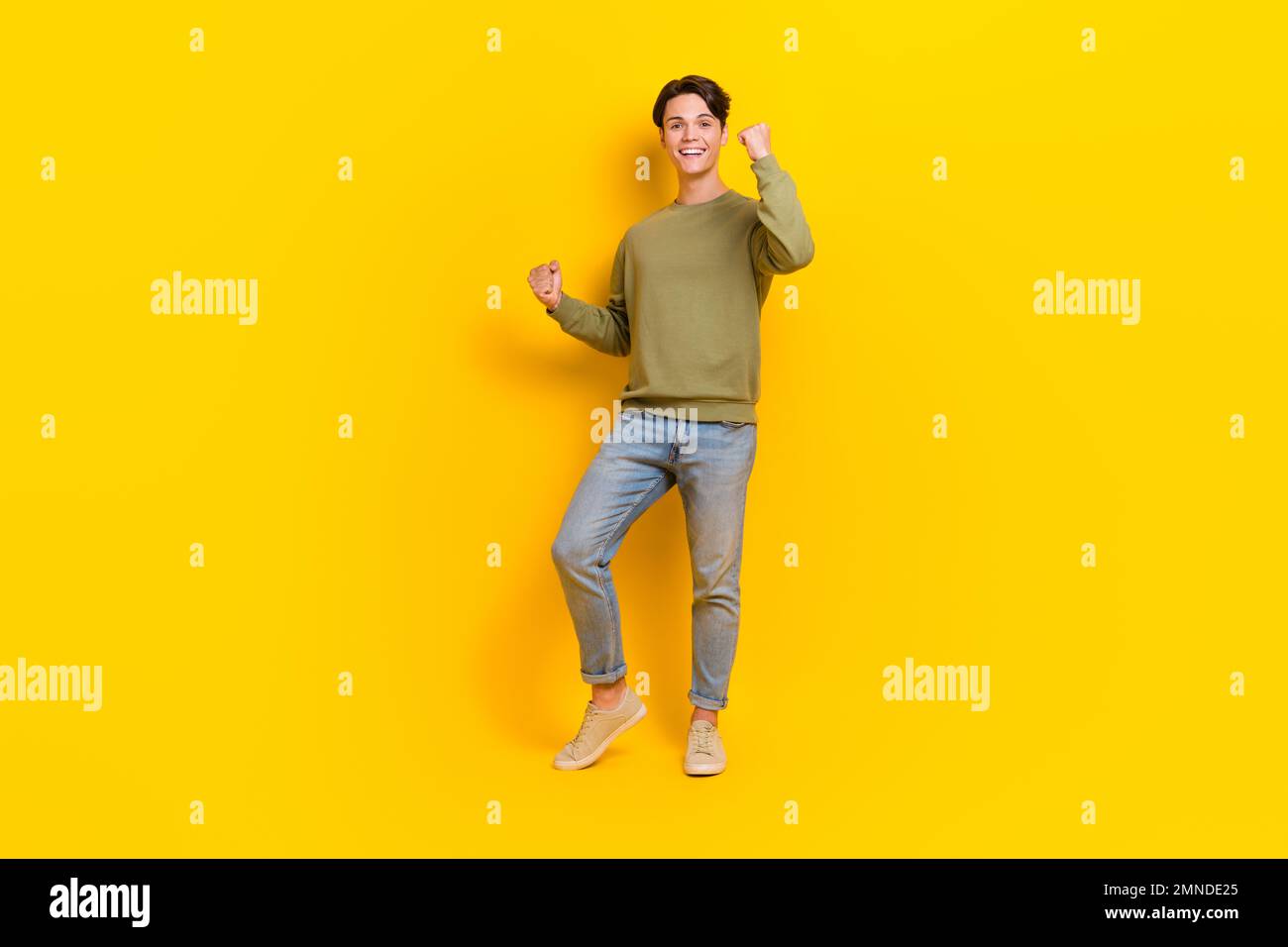 Full size photo of delighted positive man raise fists luck ...