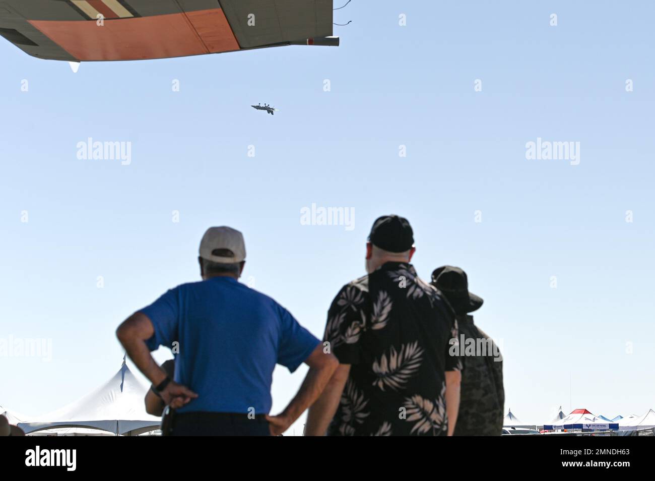 People watch a fighter jet fly during the California Capital Airshow at ...