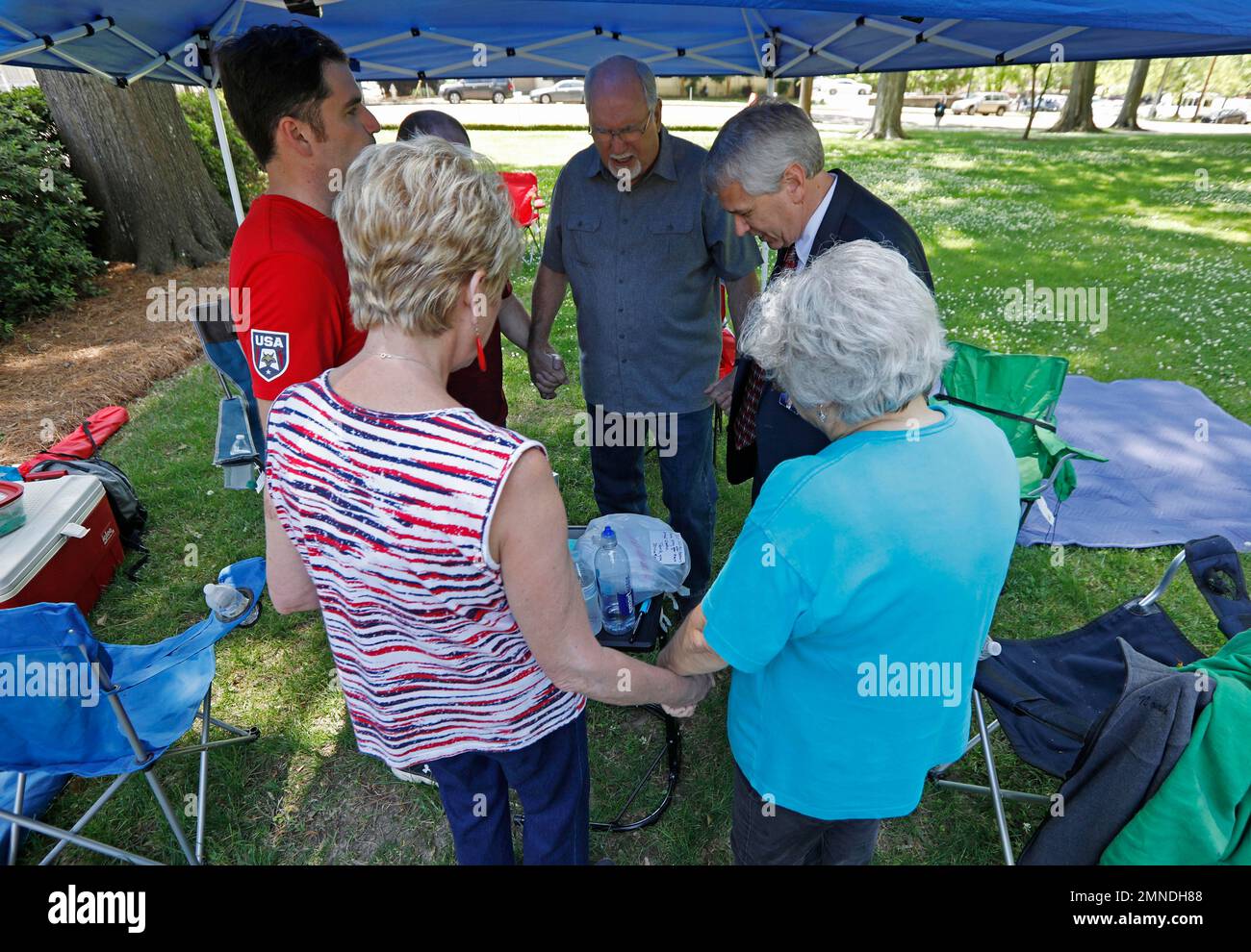 Attendees take advantage of a prayer tent to offer prayers at a daylong ...