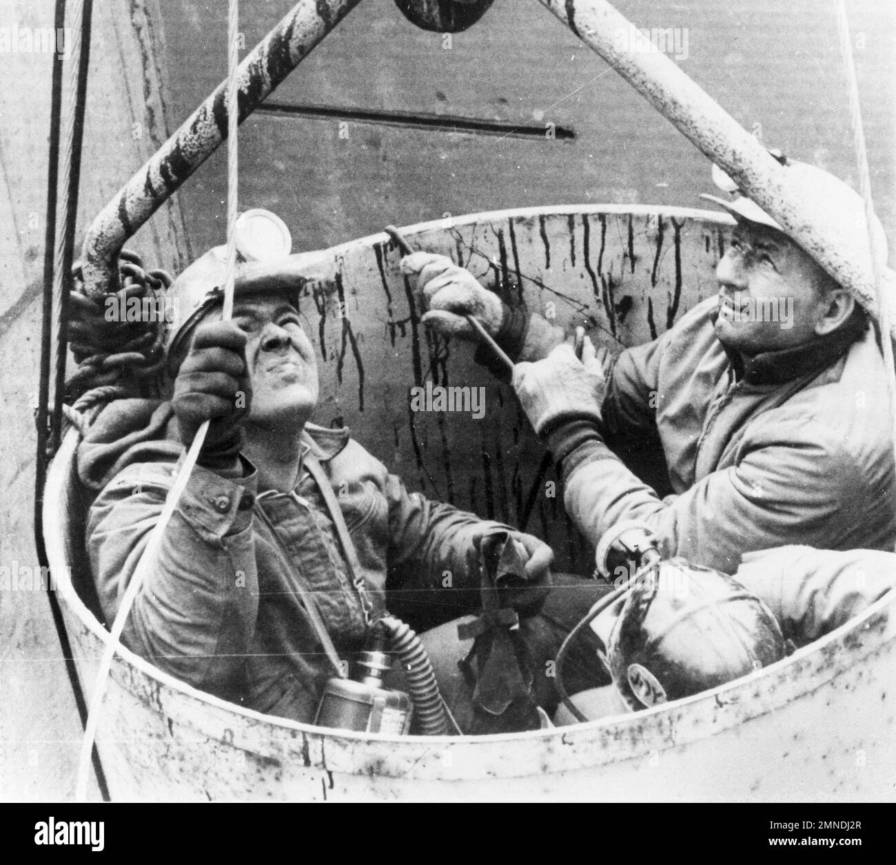 Three miners are lifted by a bucket from the burning Mountaineer Coal ...