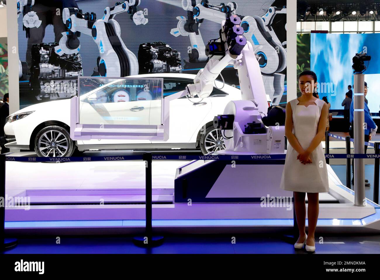 In this April 26, 2018, photo, an industrial robot is displayed with a ...