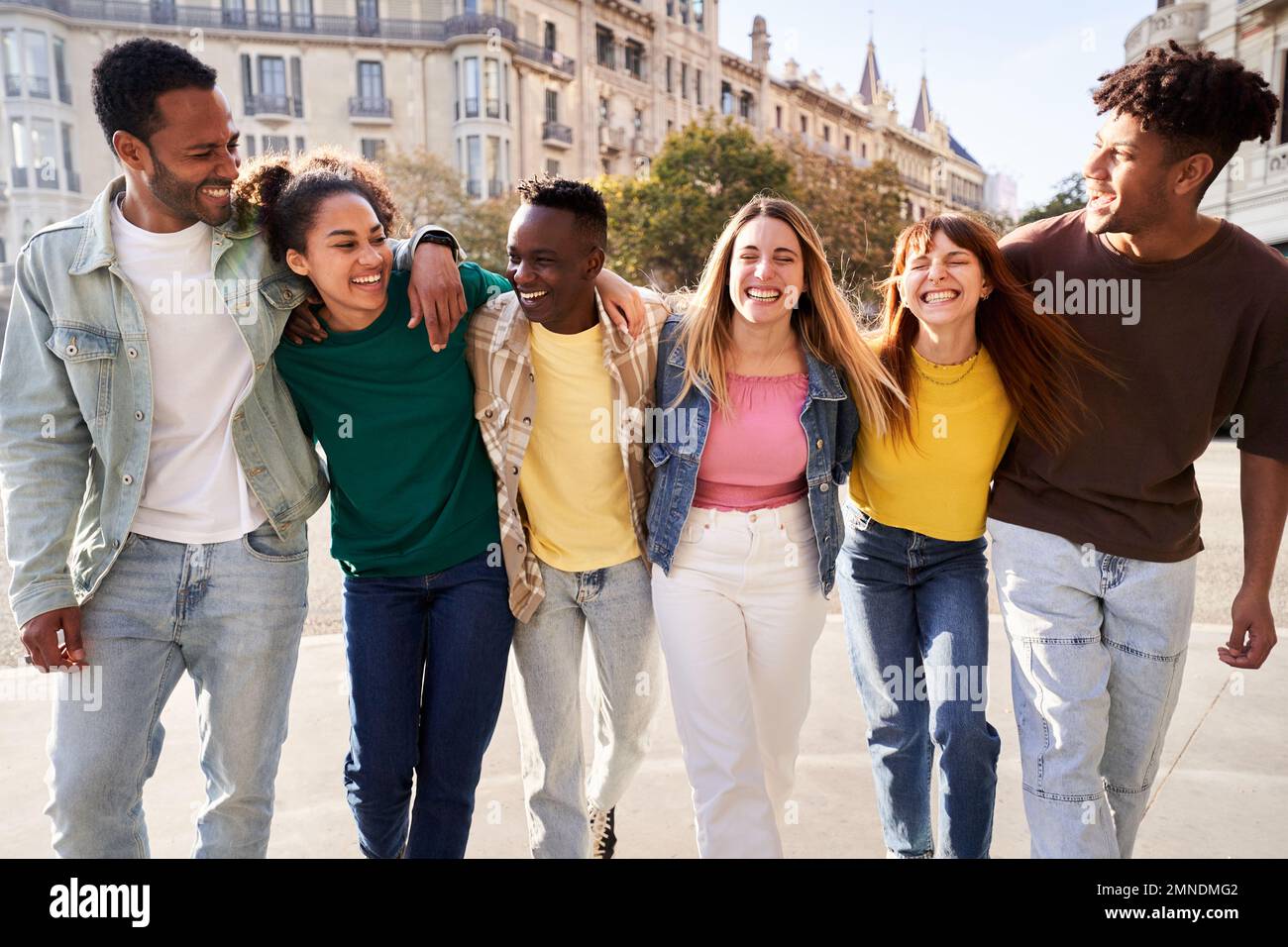 Happy international group of friends walking in the city street having fun together Stock Photo ...