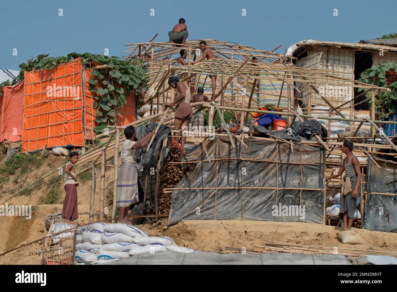 In this Saturday, April 28, 2018, photo, Rohingya refugees rebuild ...