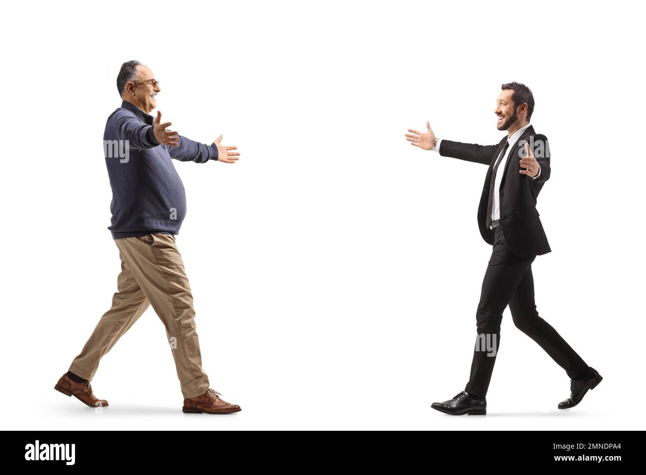 Full length profile shot of a young busniessman walking to hug a mature ...