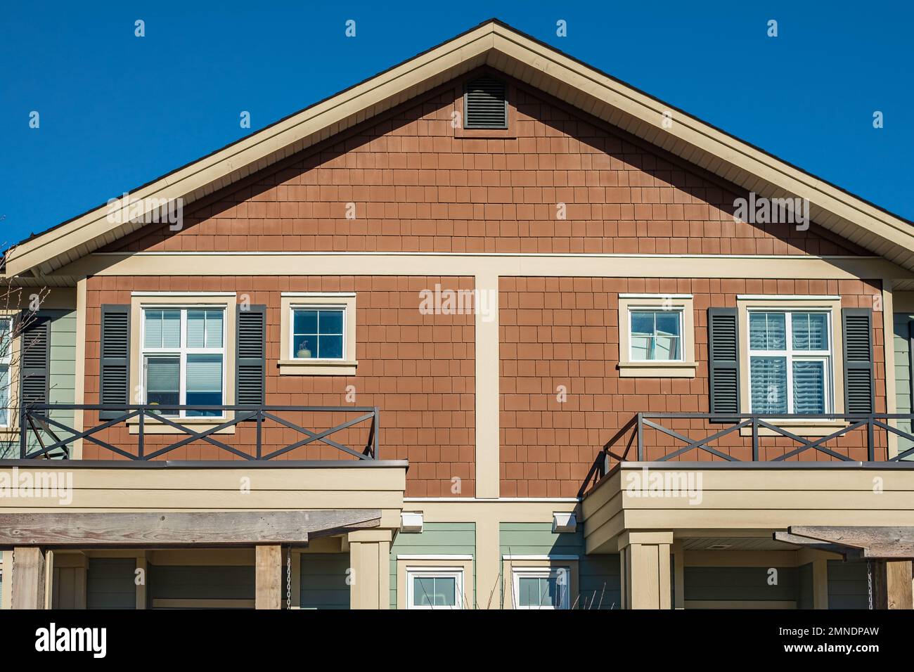 Top of a house with nice windows. Dormer in the blue sky background ...