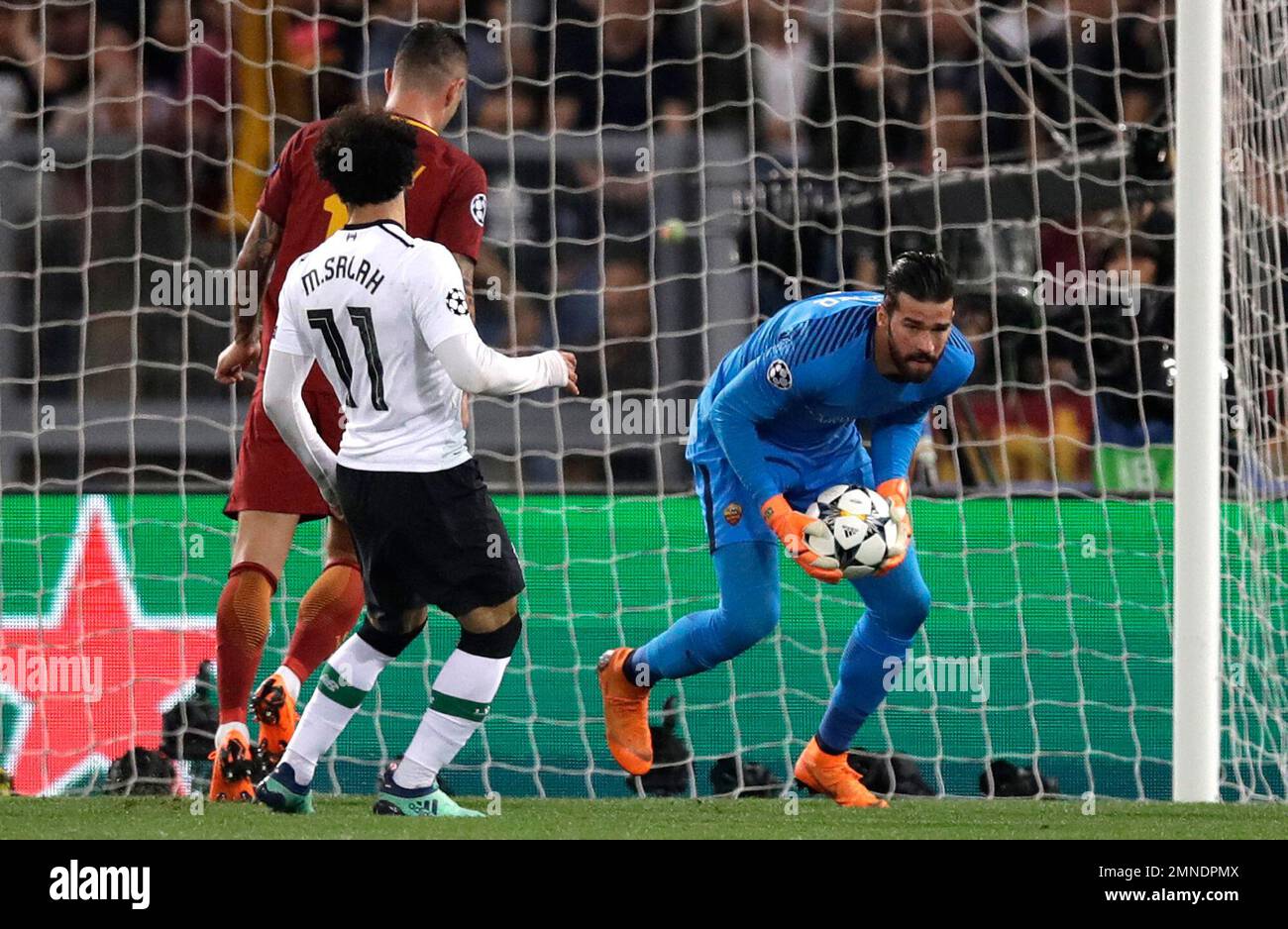 Roma goalkeeper Alisson Becker, right, catches the ball ahead of ...