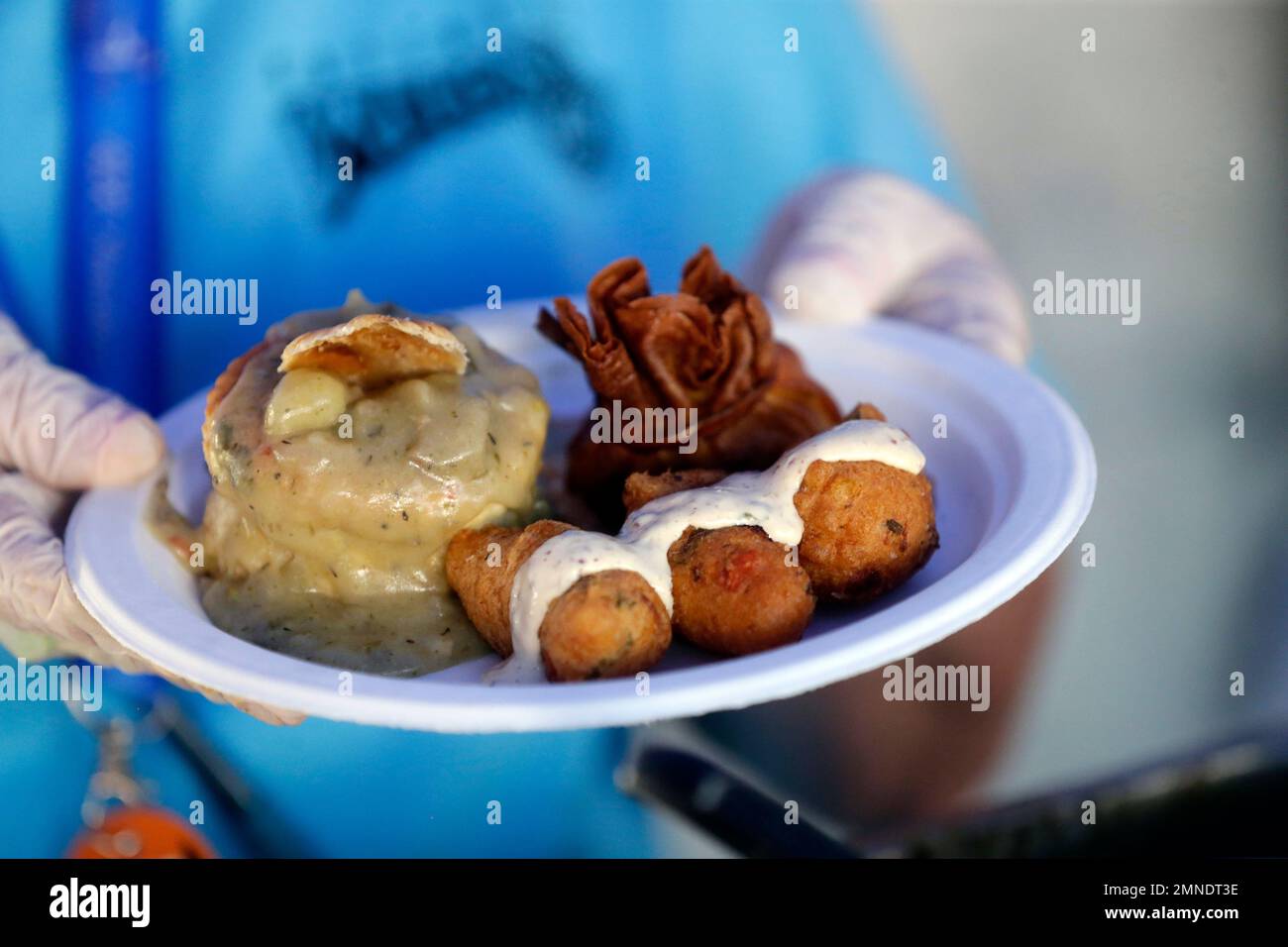 FILE - In this May 1, 2015, file photo, an employee serves a plate with ...