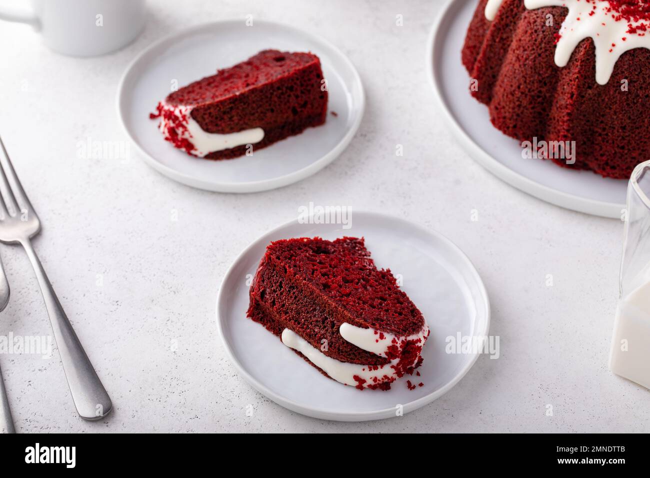 Red velvet bundt cake with cream cheese frosting and cake crumbs Stock ...