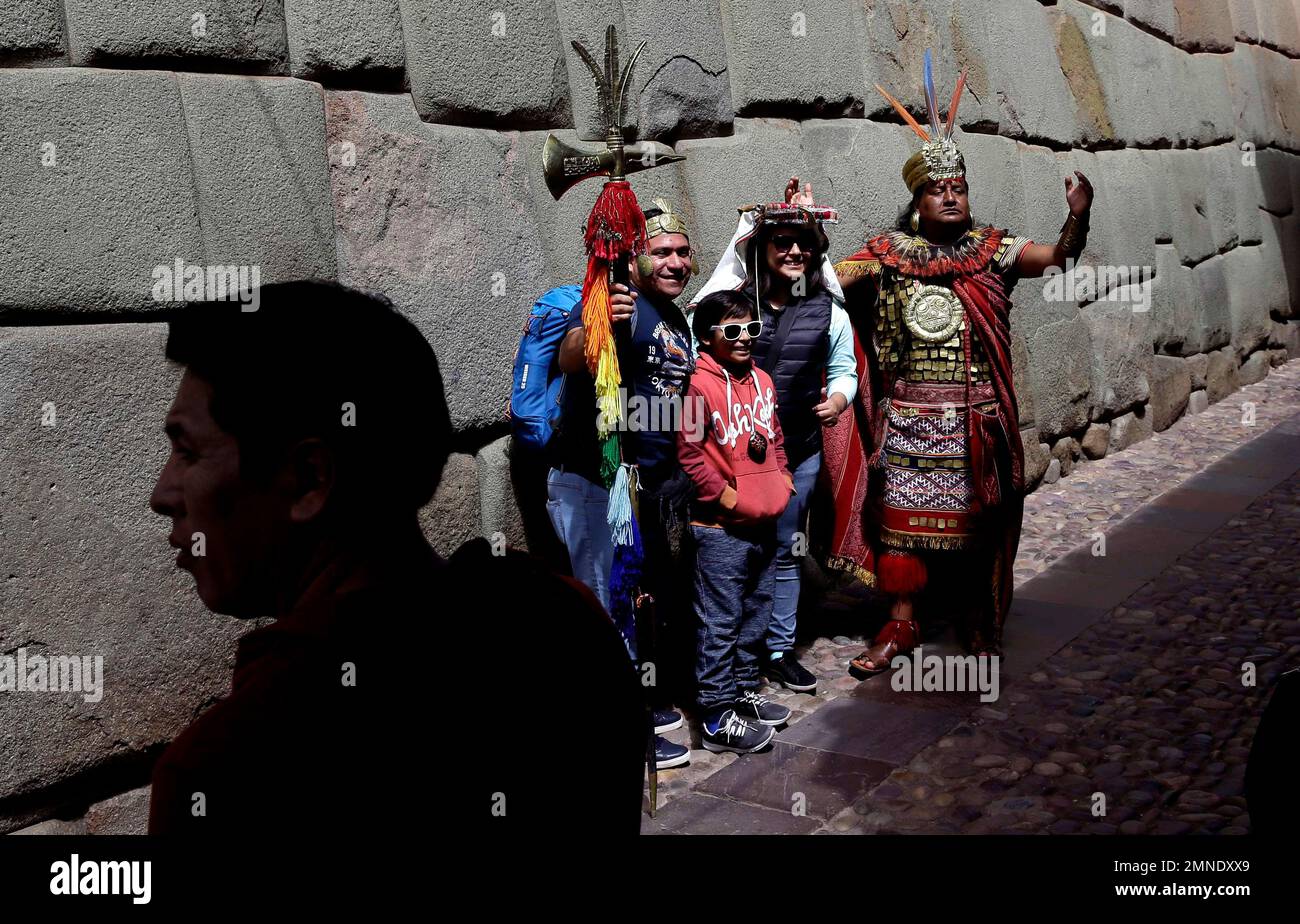 A family poses for a portrait with a man dressed as Inca ruler Manco ...
