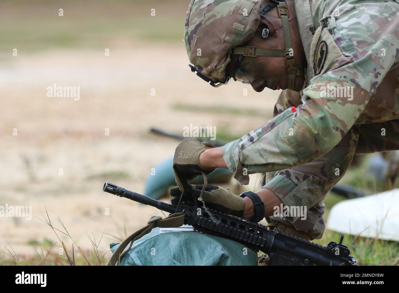 A Soldier of Squad 7, United States Army Reserve, makes adjustments to ...