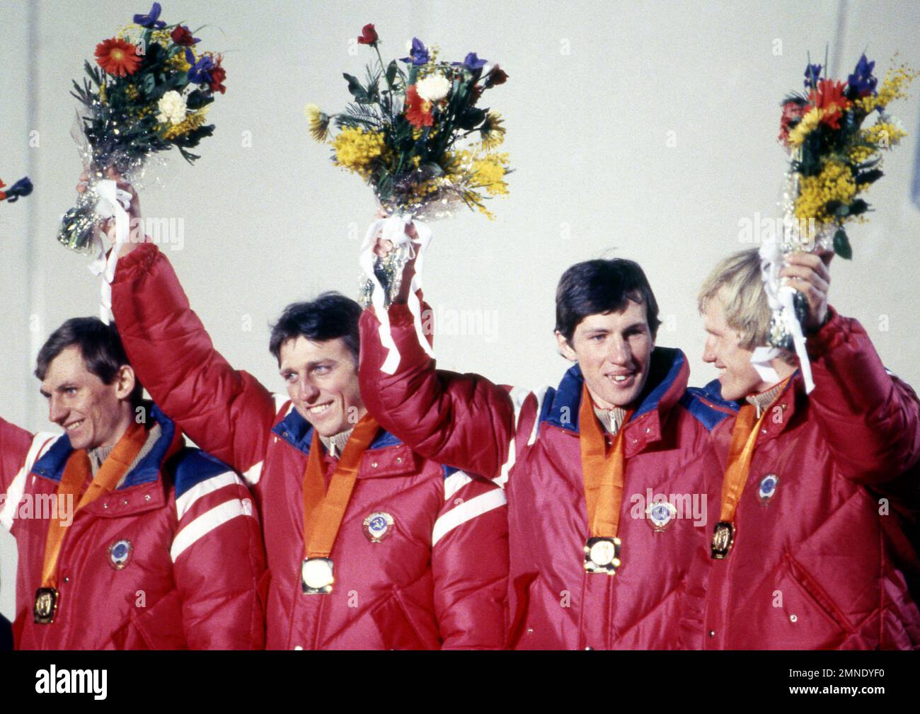 The 4 x 7.5km relay team for the Soviet Union stand on the podium after receiving their gold ...