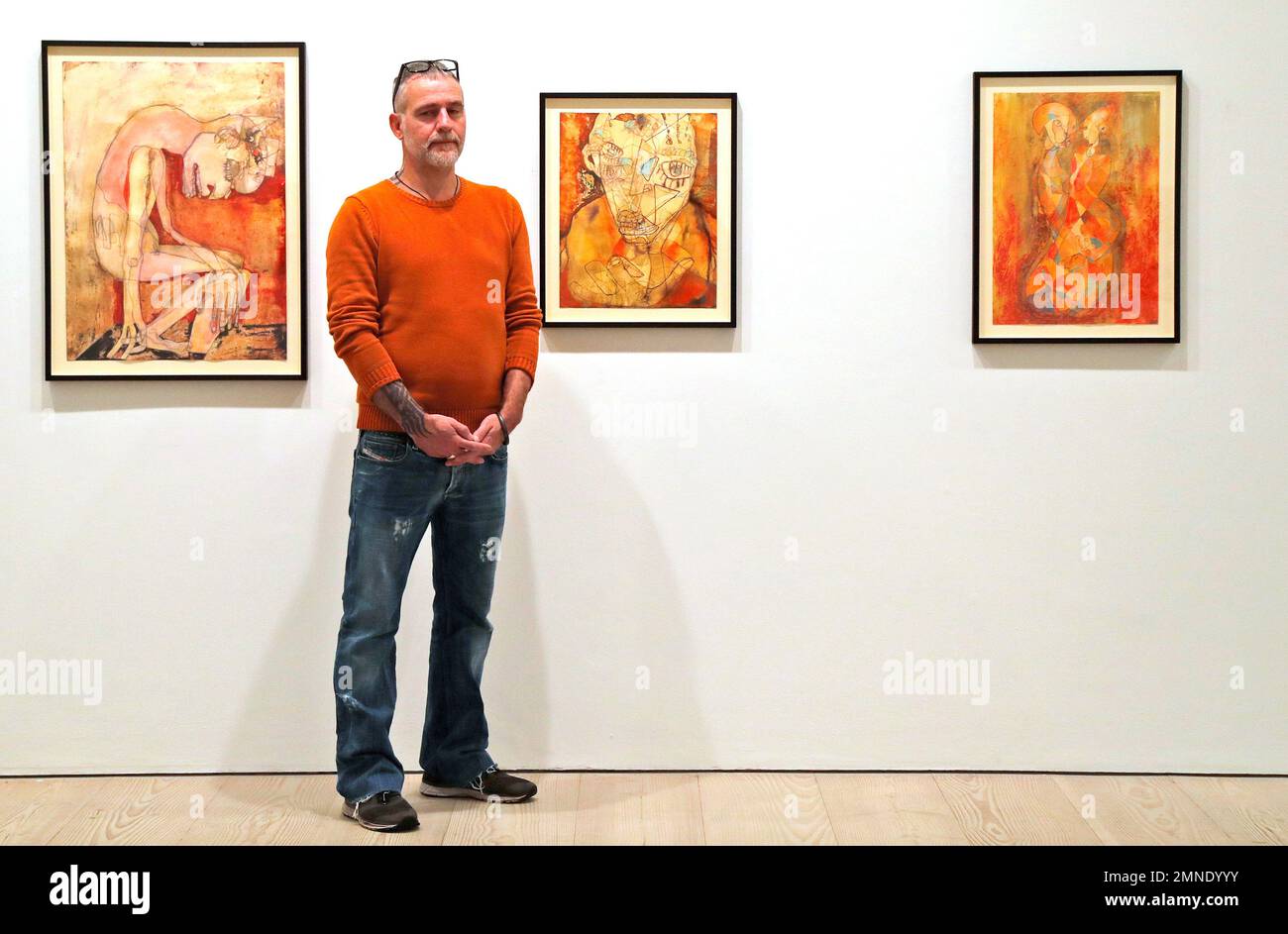 Artist Yap poses with his paintings, from left, Anxiety, The ...
