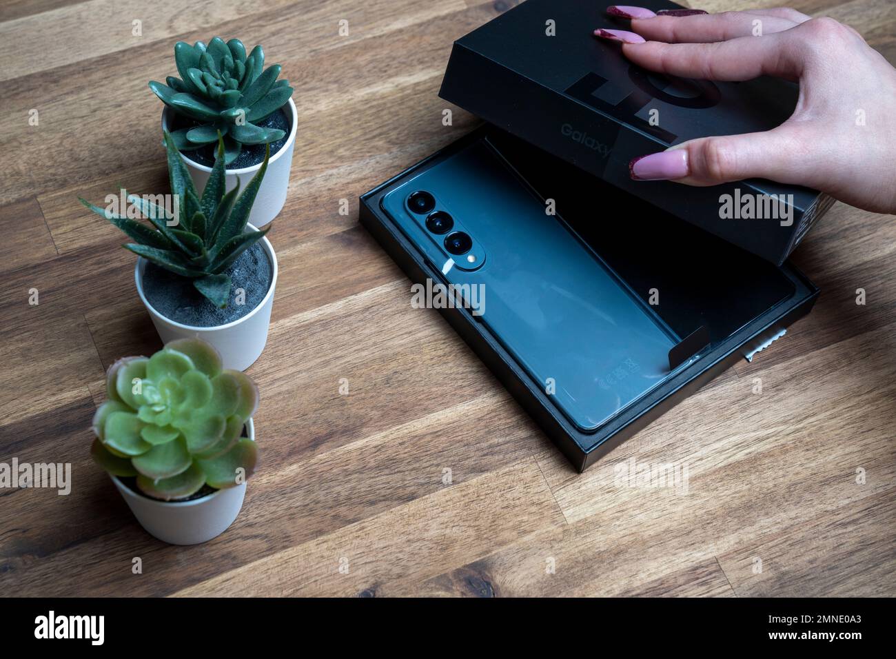 Samsung Galaxy Z Fold 4 in grey-green color. The device is in the open ...