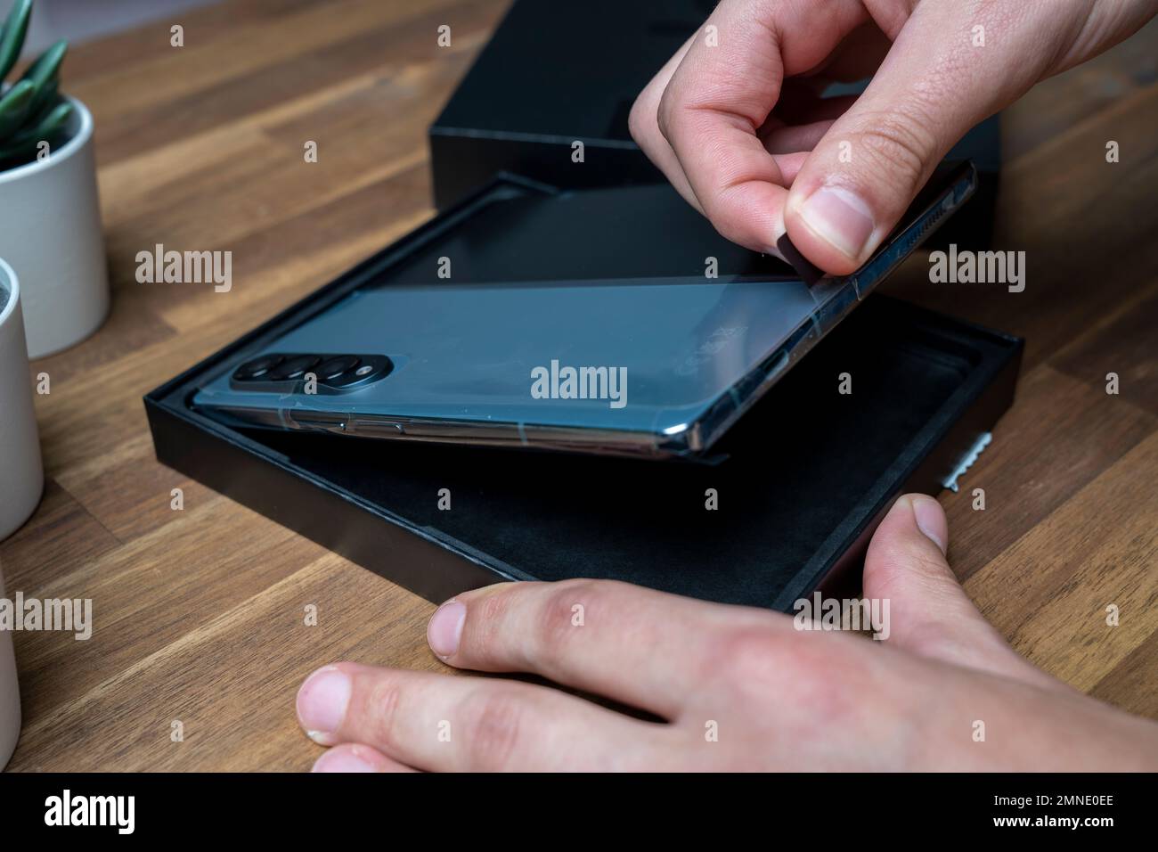 Samsung Galaxy Z Fold 4 in gray-green color. A man unpacks the new ...