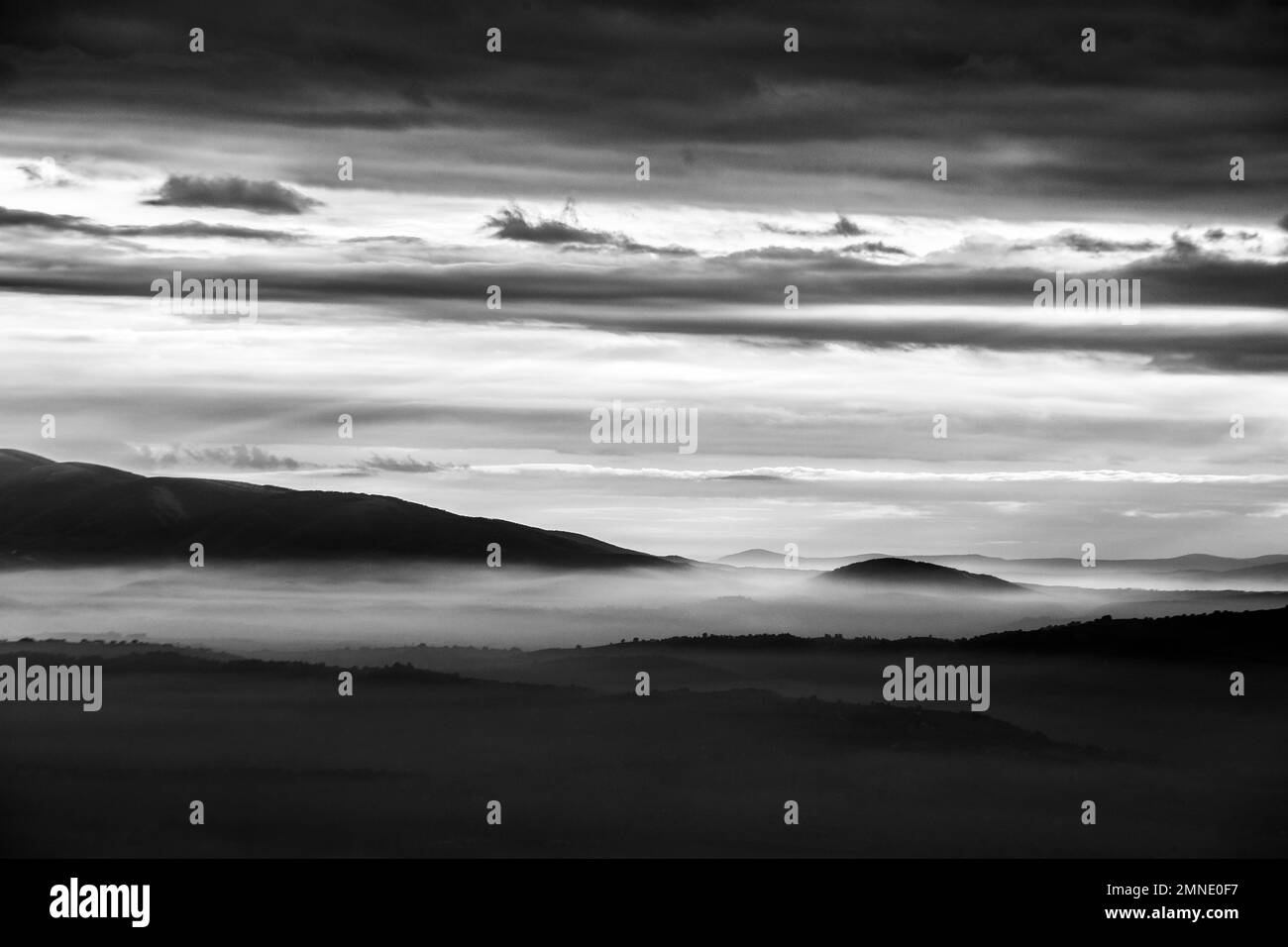 Mist and fog between valley and layers of mountains and hills Stock ...