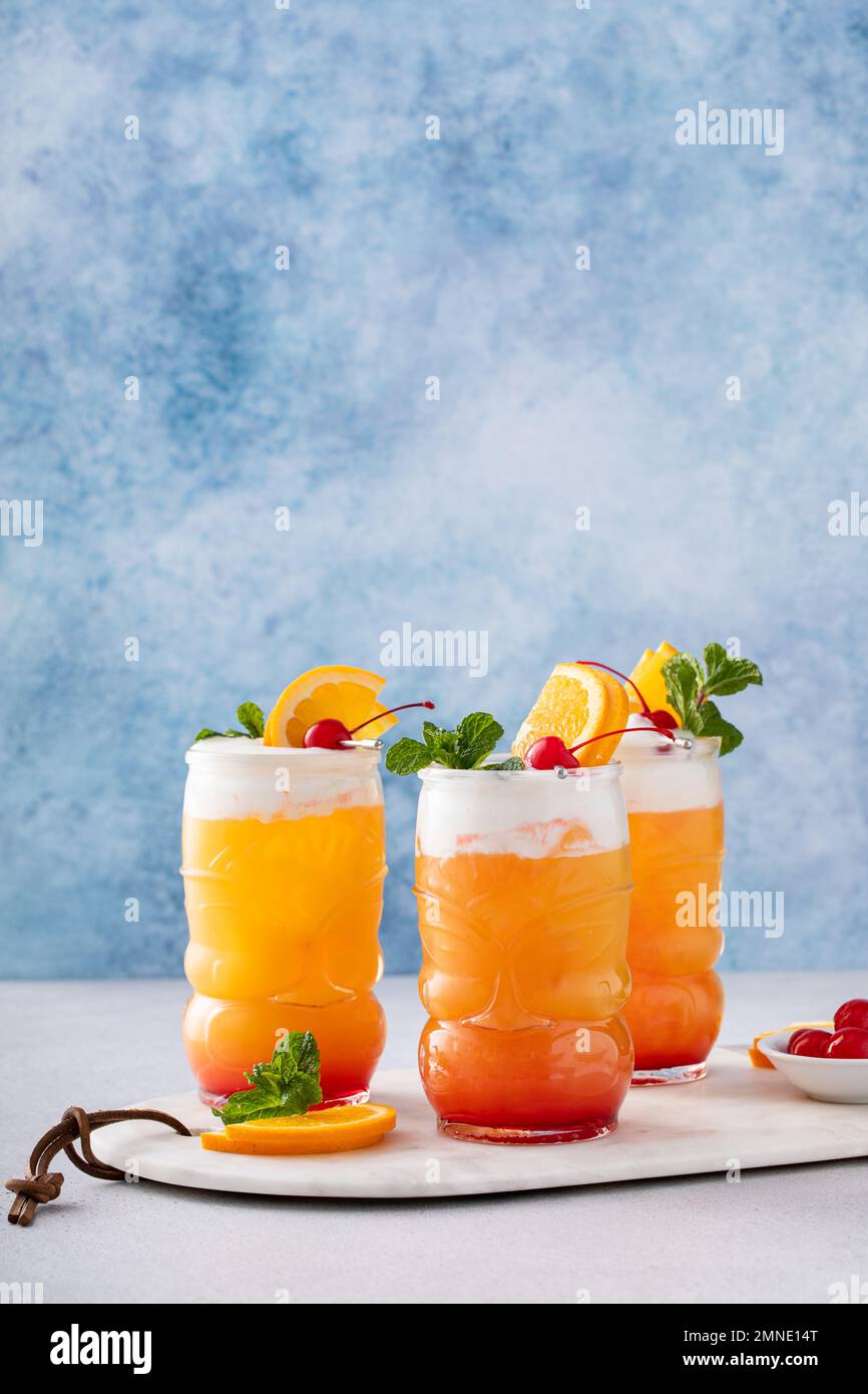 Zombie tropical cocktail with rum in tiki glasses Stock Photo - Alamy