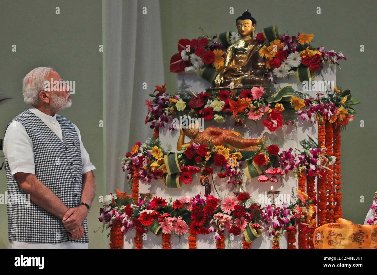 Indian Prime Minister Narendra Modi looks at idols of Lord Buddha ...