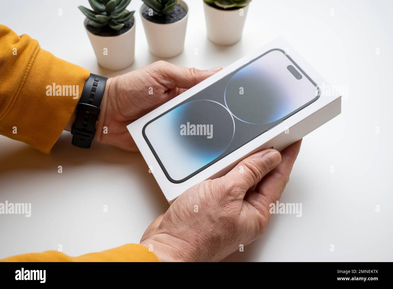 A man holds the latest iPhone 14 Pro Max in Space Black. Apple's latest ...