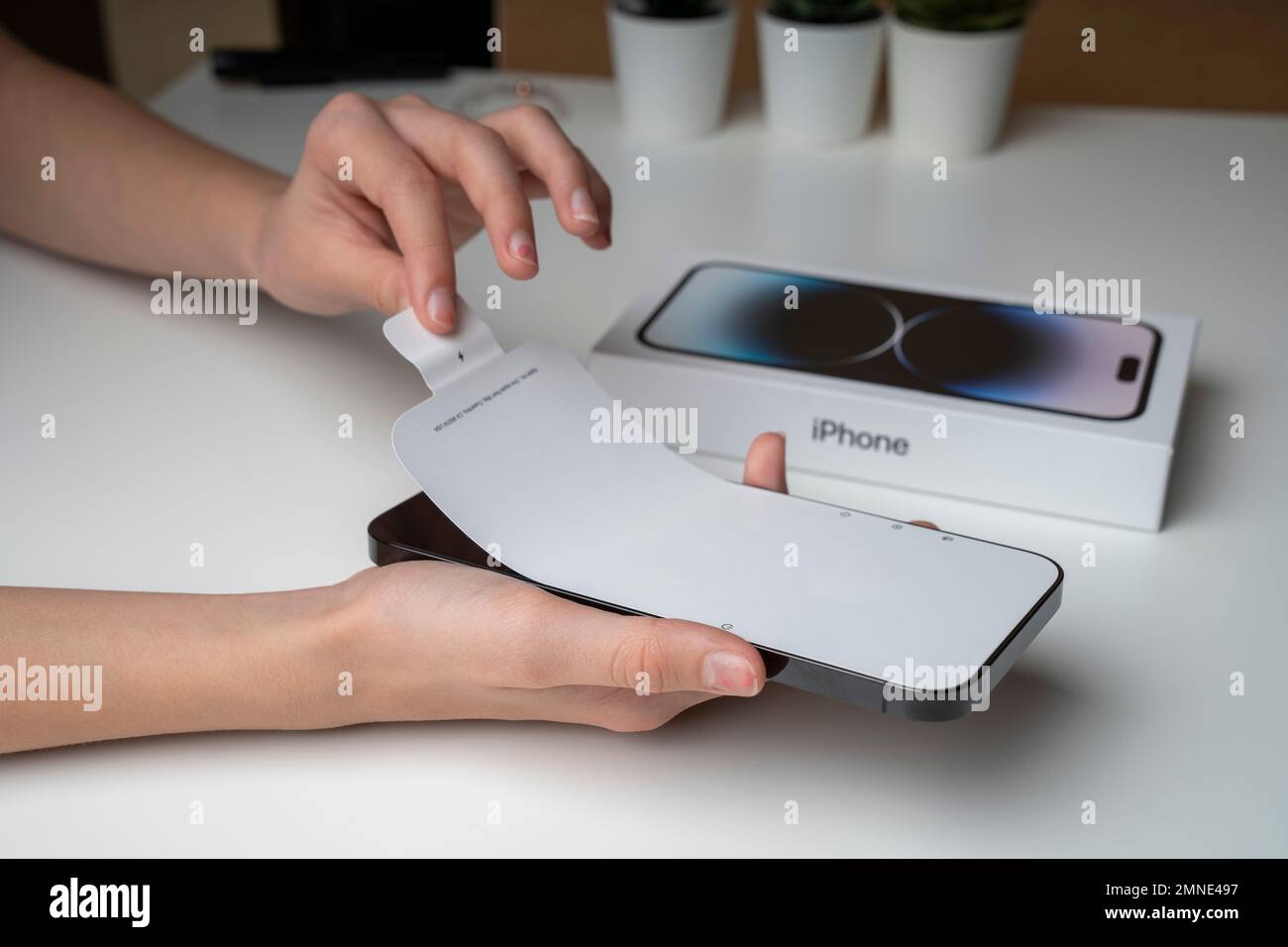 A girl holds the latest iPhone 14 Pro Max, Space Black. Apple's latest ...
