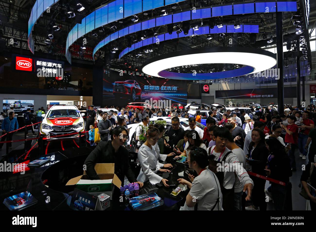 Visitors crowd at the Chinese auto brand BYD exhibition booth counter ...