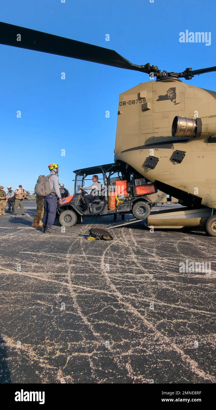 A civilian search and rescue vehicle loads on board a CH-47F Chinook ...
