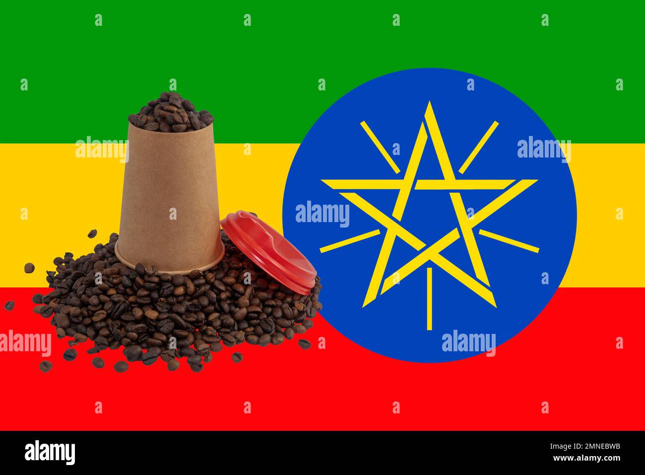 An overturned disposable paper cup with a lid filled with roasted ...