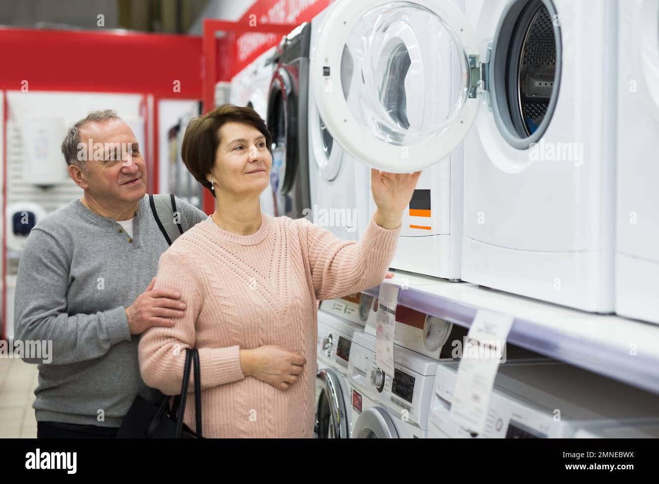 Mature woman washing machine hi-res stock photography and images - Alamy