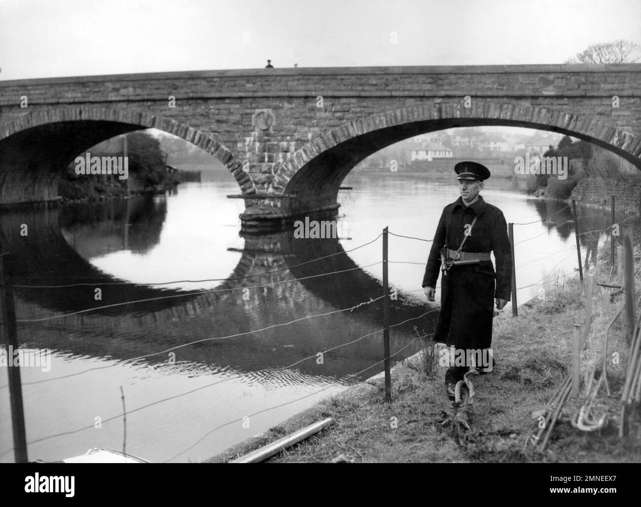 Armed men of the Royal Ulster Constabulary patrol a bridge over the ...