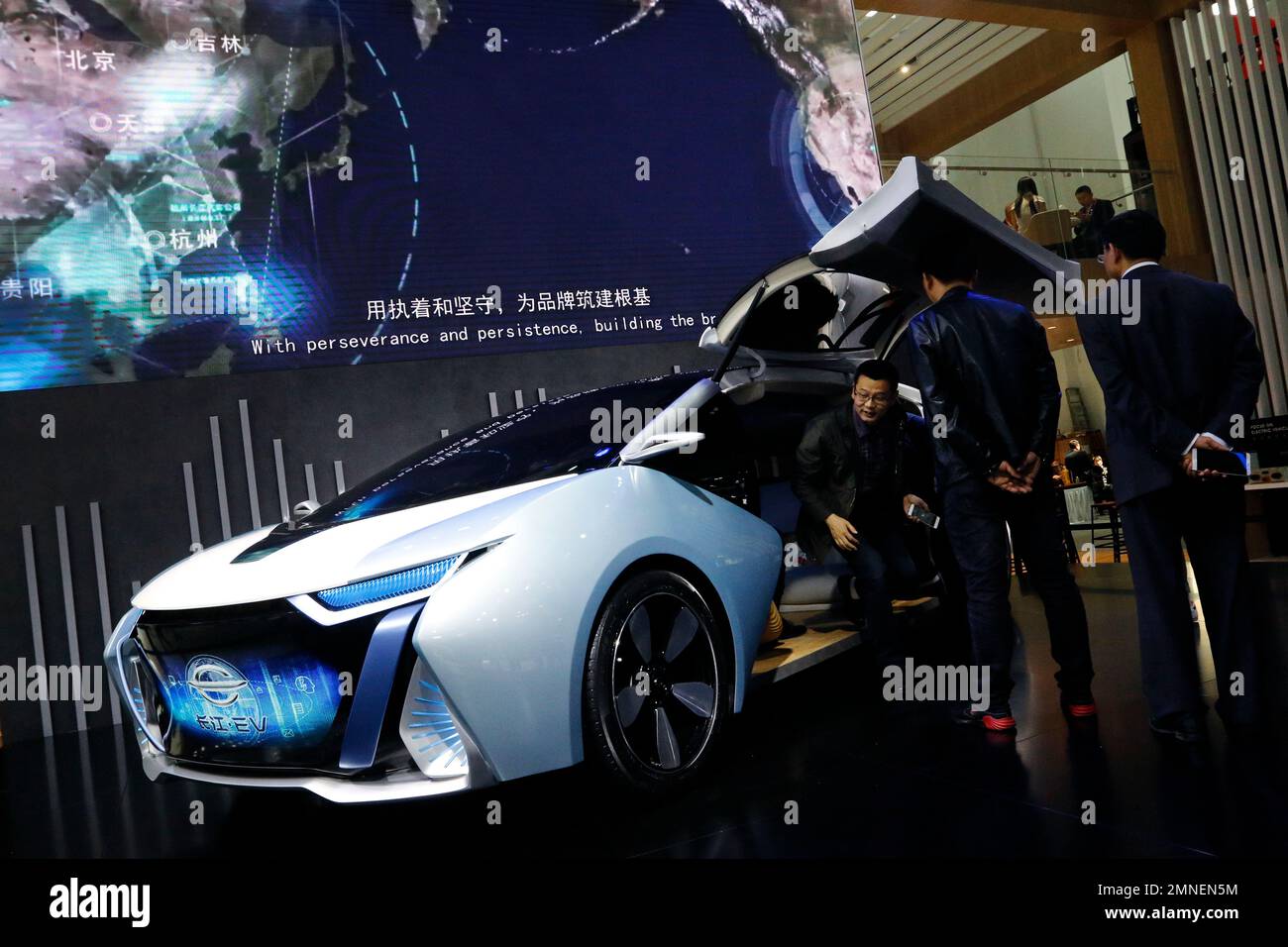 Visitors sit in a Chinese car brand Chang Jiang EV concept car on display at the China Auto China in Beijing Thursday April 26 2018. Auto China 2018 the industry s biggest sales